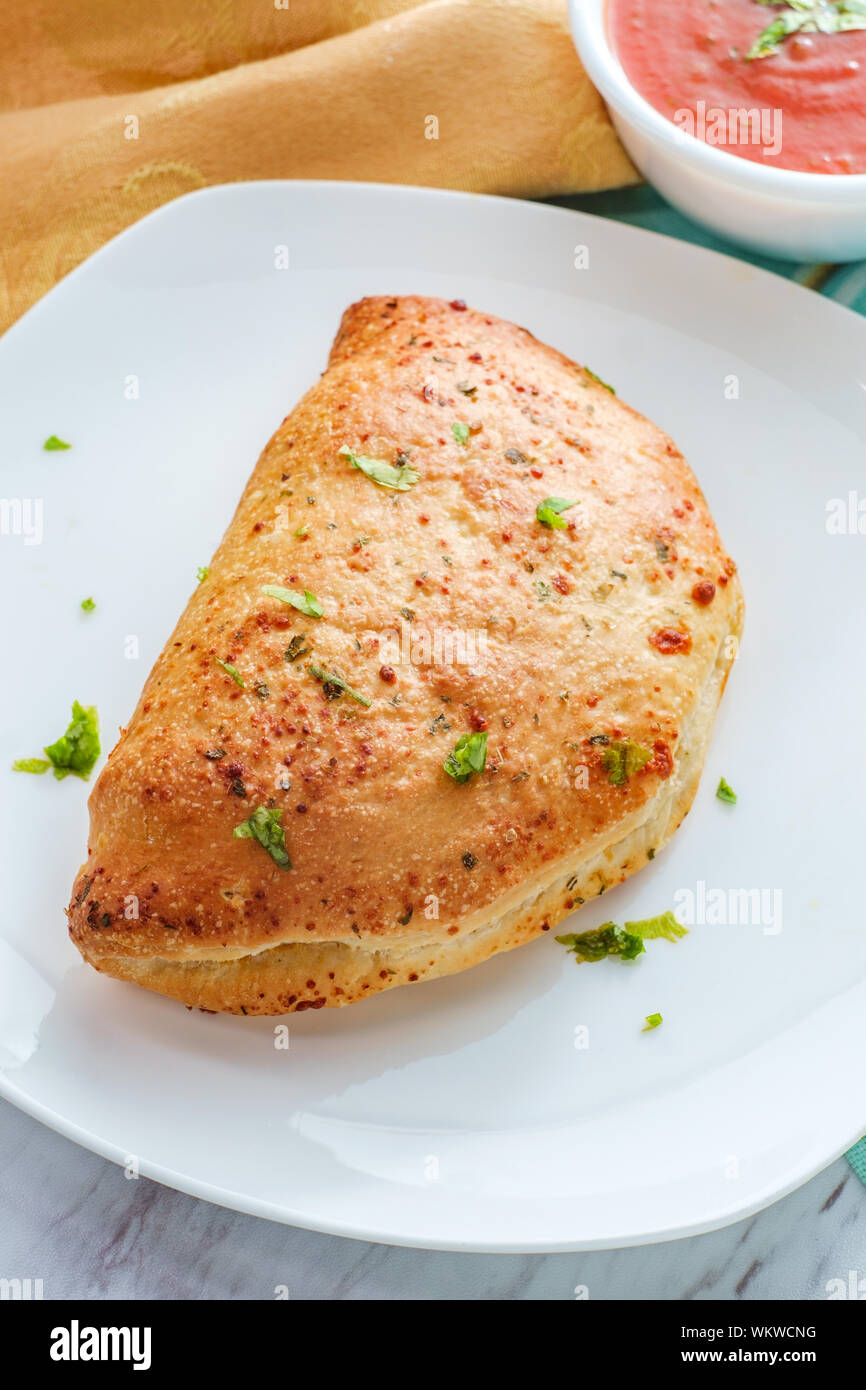 Italian pastry pepperoni and cheese calzone with tomato marinara ...