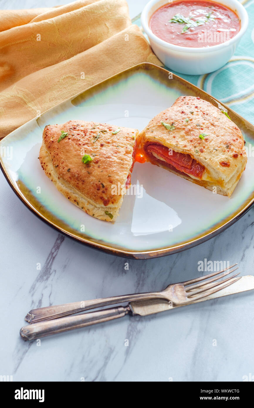 Italian pastry pepperoni and cheese calzone with tomato marinara ...