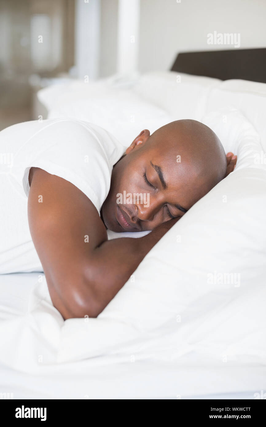 Peaceful man sleeping in bed at home in bedroom Stock Photo - Alamy