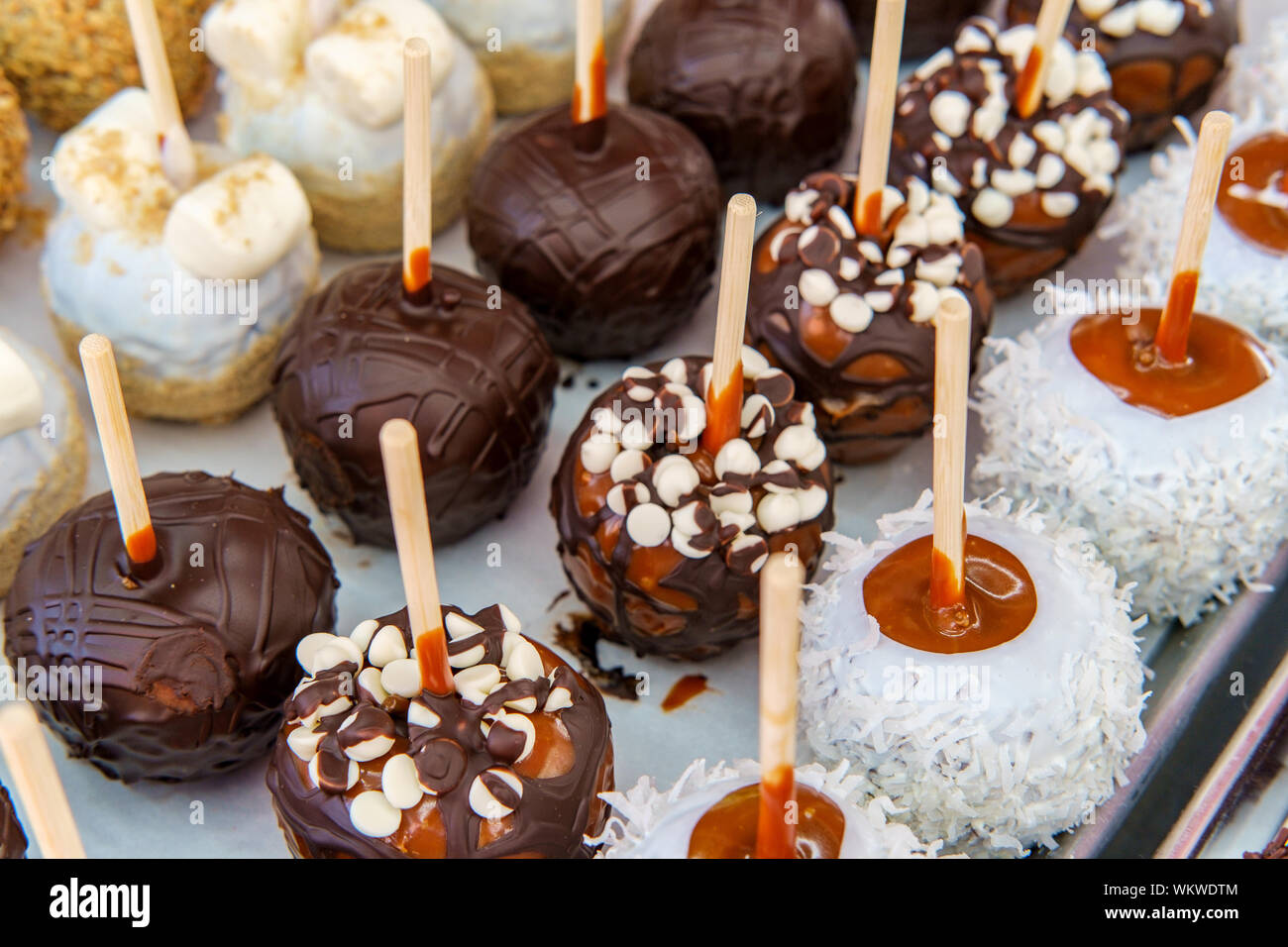 Tray of assorted variety of candy apples at state fair Stock Photo - Alamy