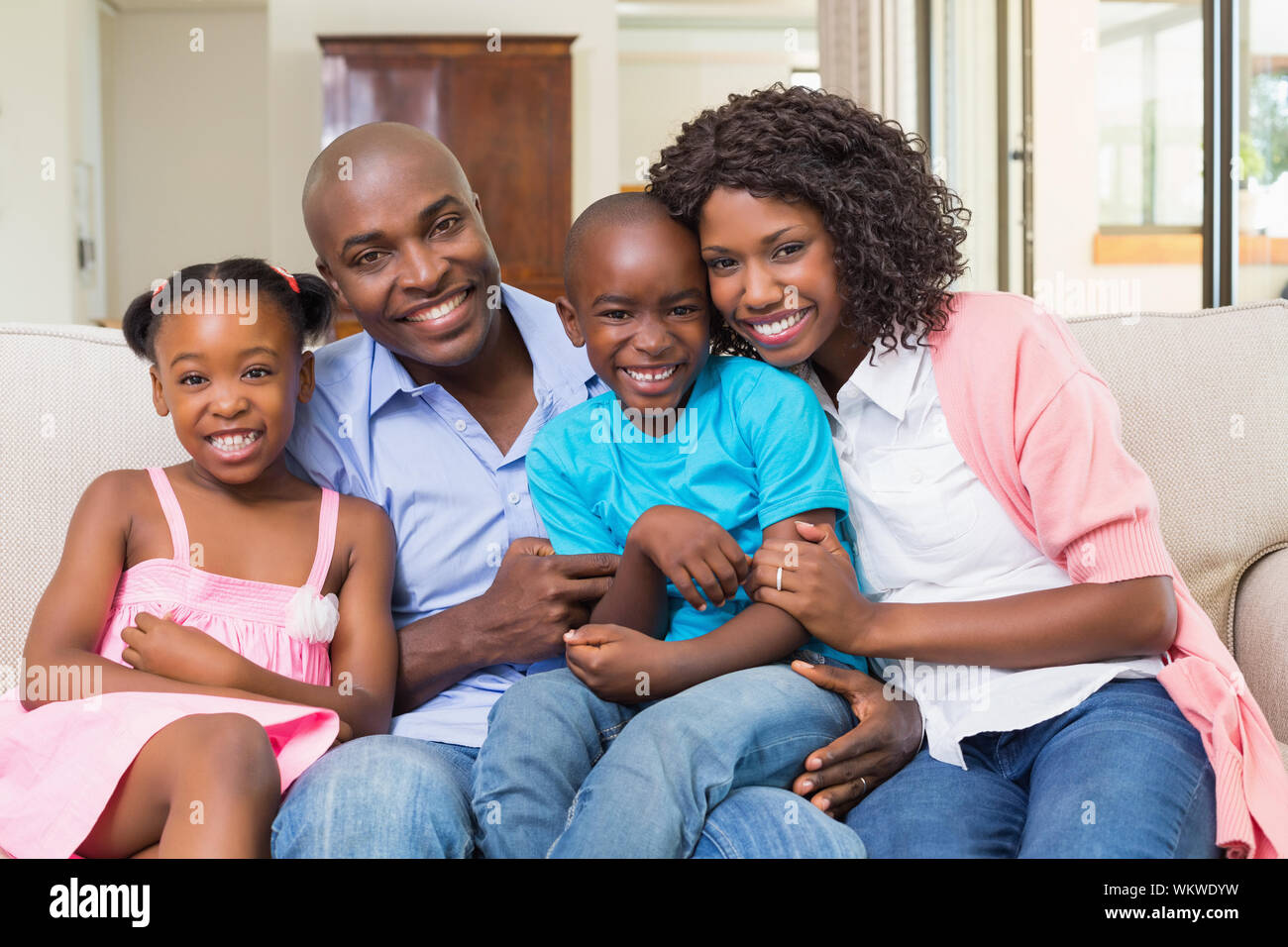 Happy family relaxing on the couch at home in the living room Stock ...