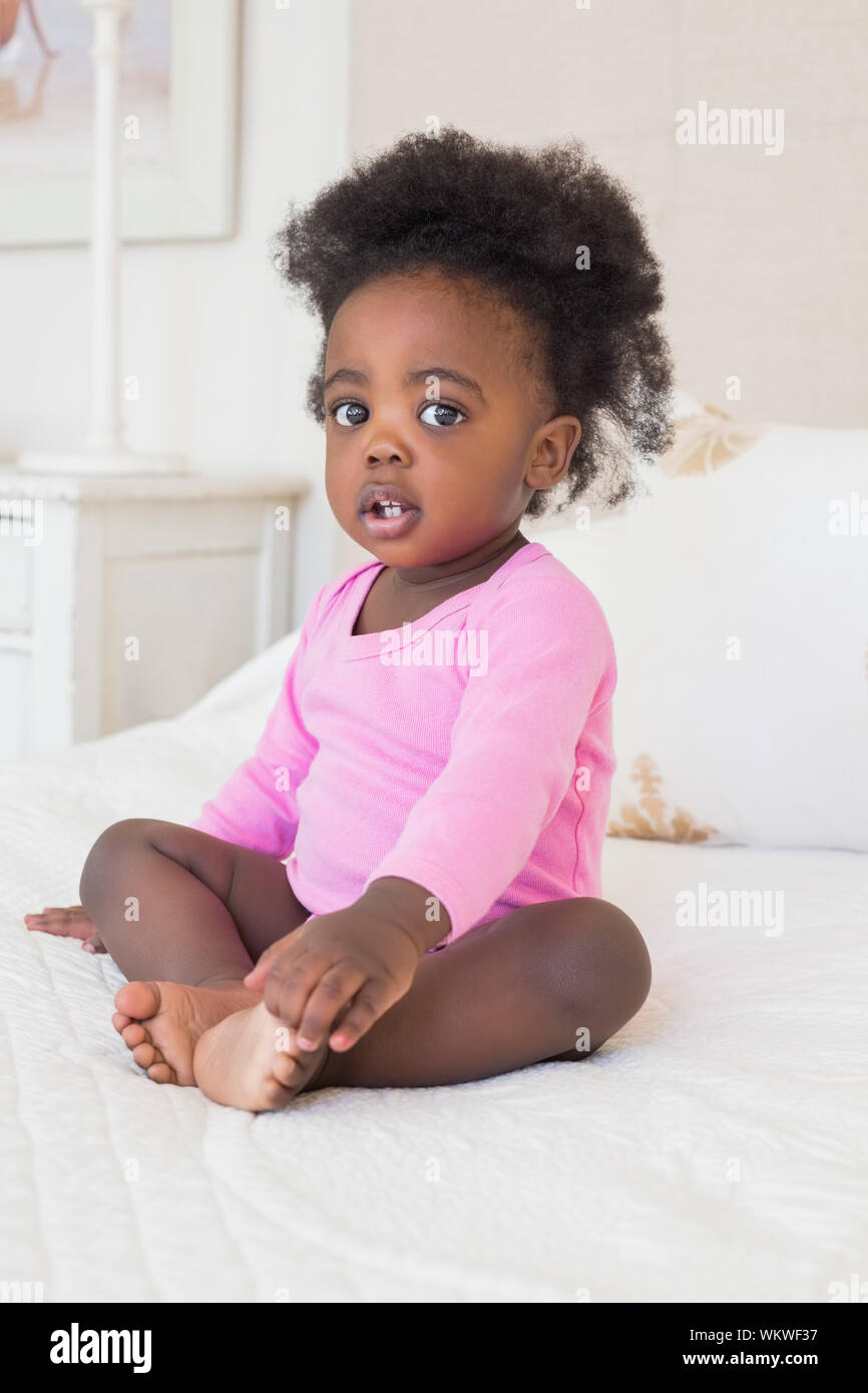 Baby girl in pink babygro hi-res stock photography and images - Alamy