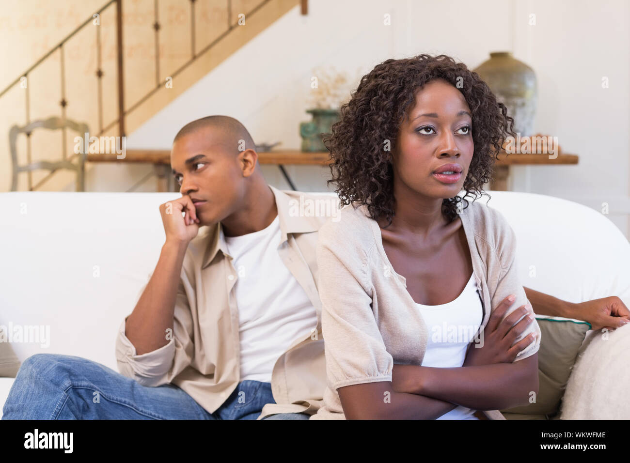Unhappy couple not speaking to each other at home in the living room ...