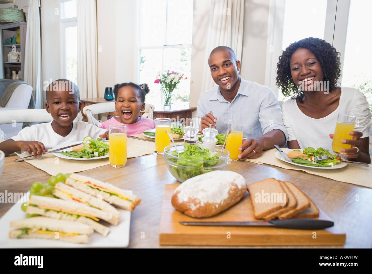 Happy family enjoying a healthy meal together at home in the kitchen ...