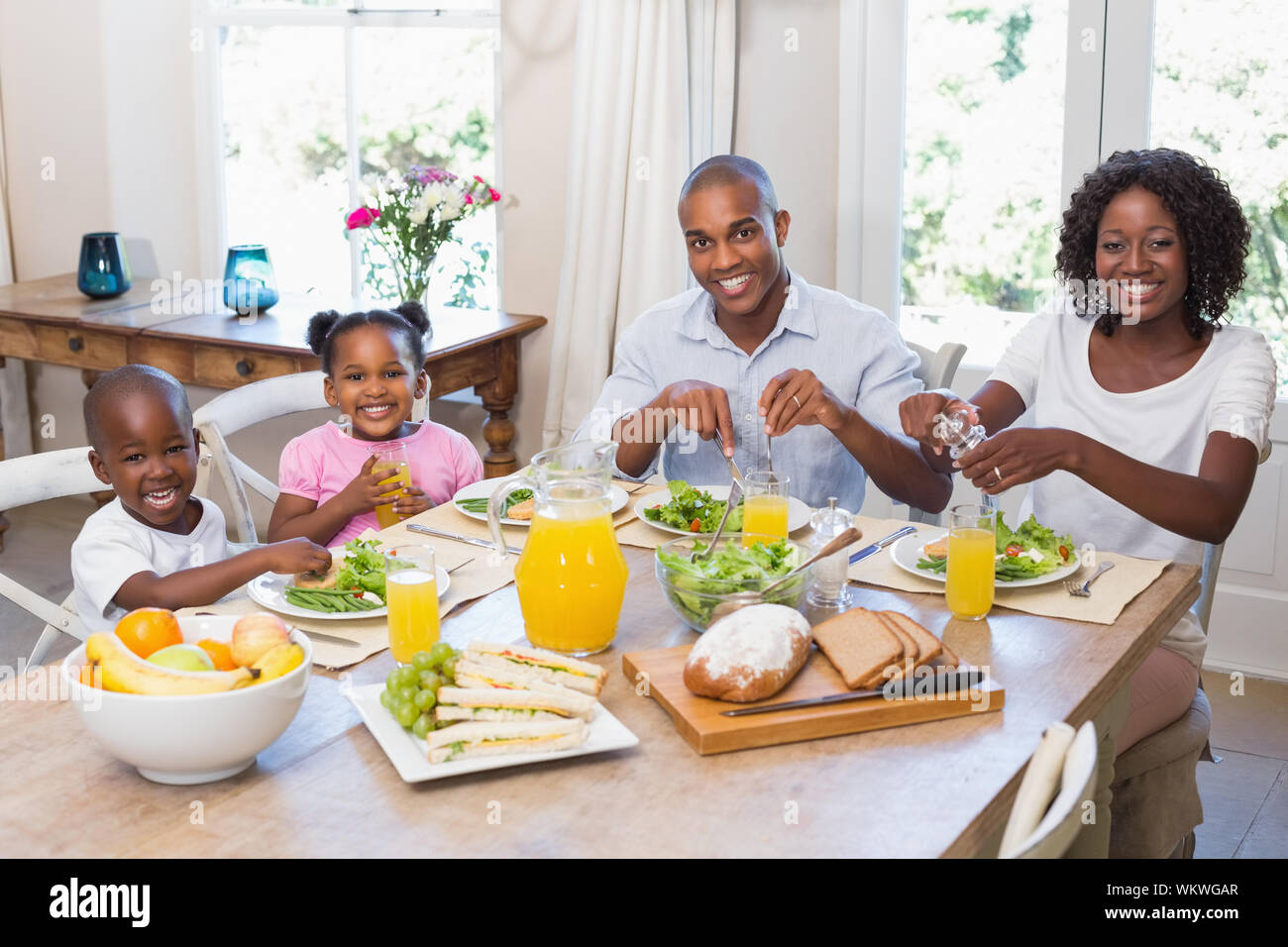 Happy family enjoying a healthy meal together at home in the kitchen ...