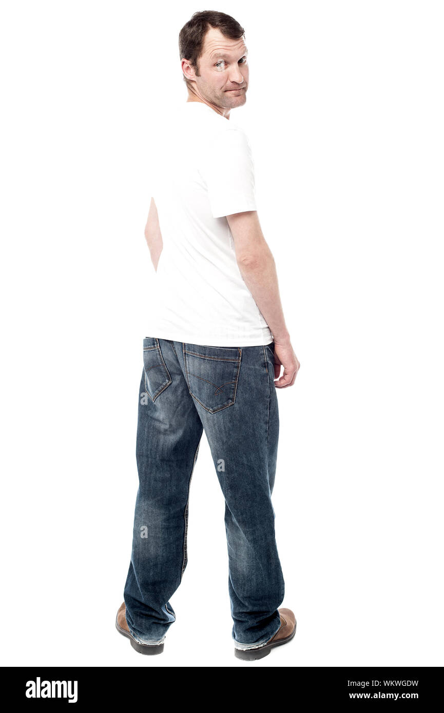 Full length view of casual middle aged man looking back Stock Photo - Alamy