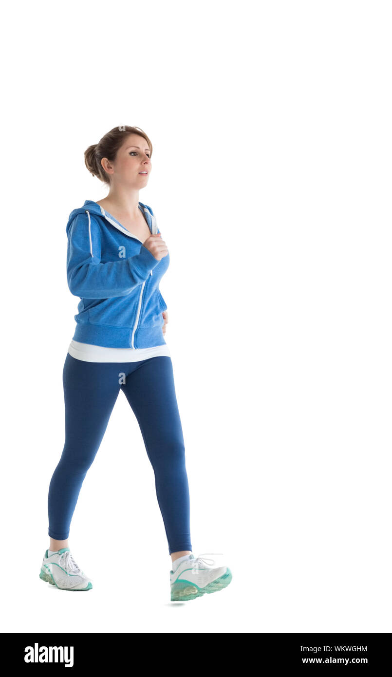 Full length of a young woman walking over white background Stock Photo ...
