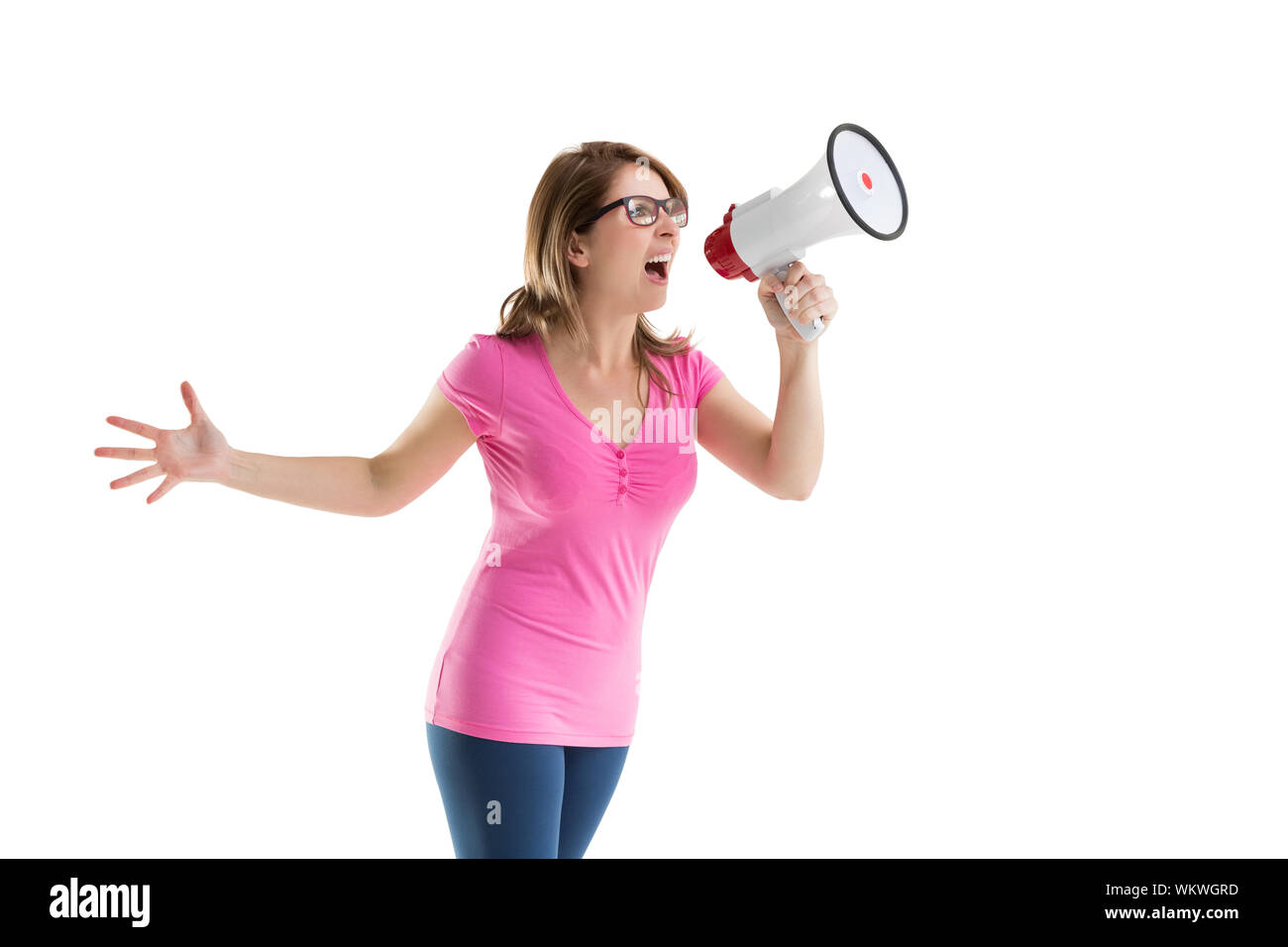Young woman shouting into bullhorn over white background Stock Photo ...
