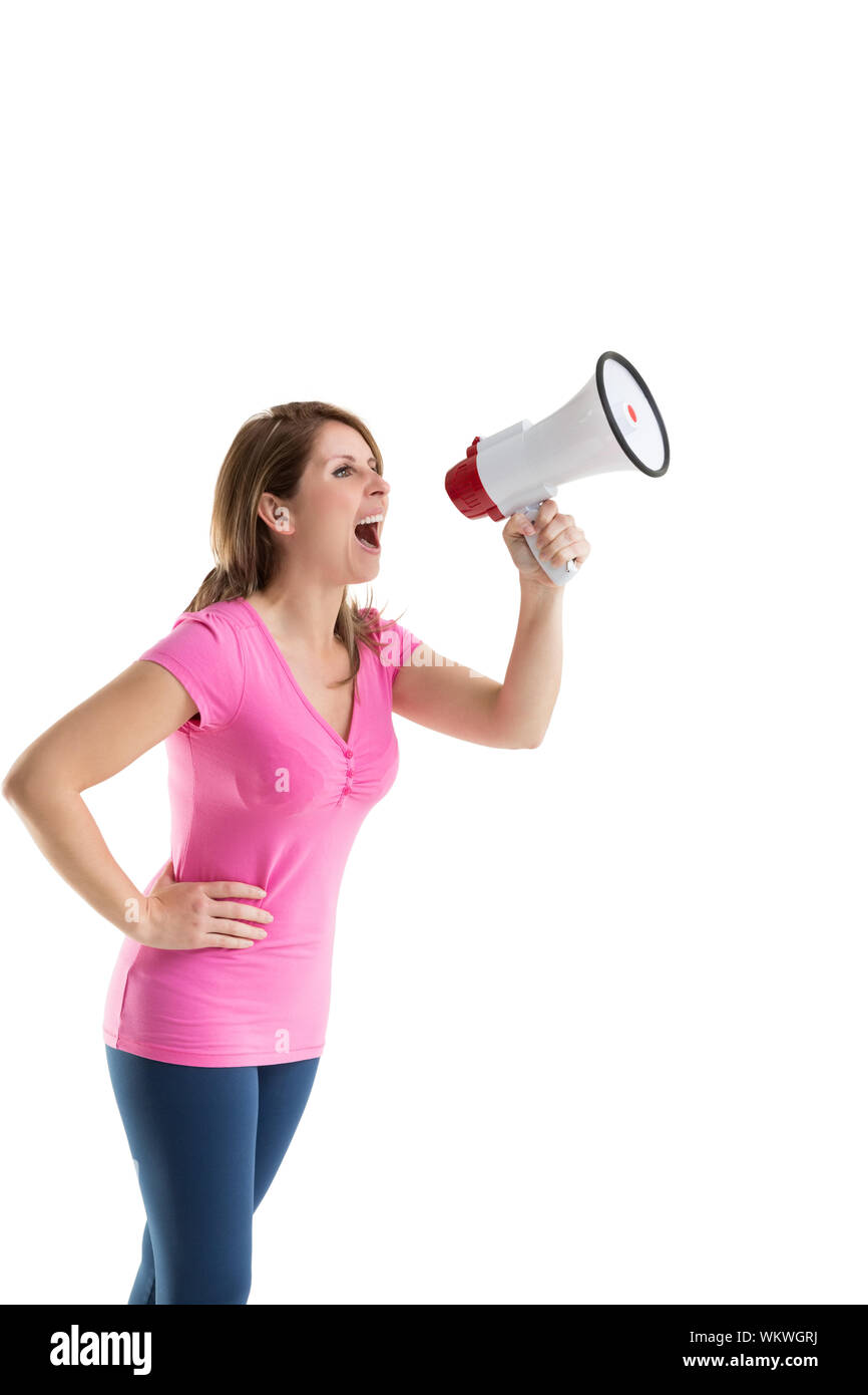 Young woman shouting into bullhorn over white background Stock Photo ...