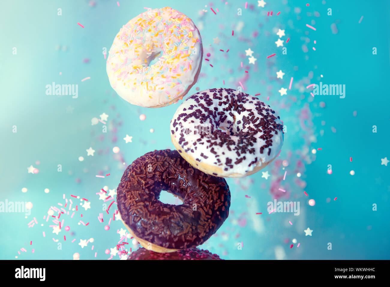 Various decorated doughnuts in motion falling Sweet and colourful ...