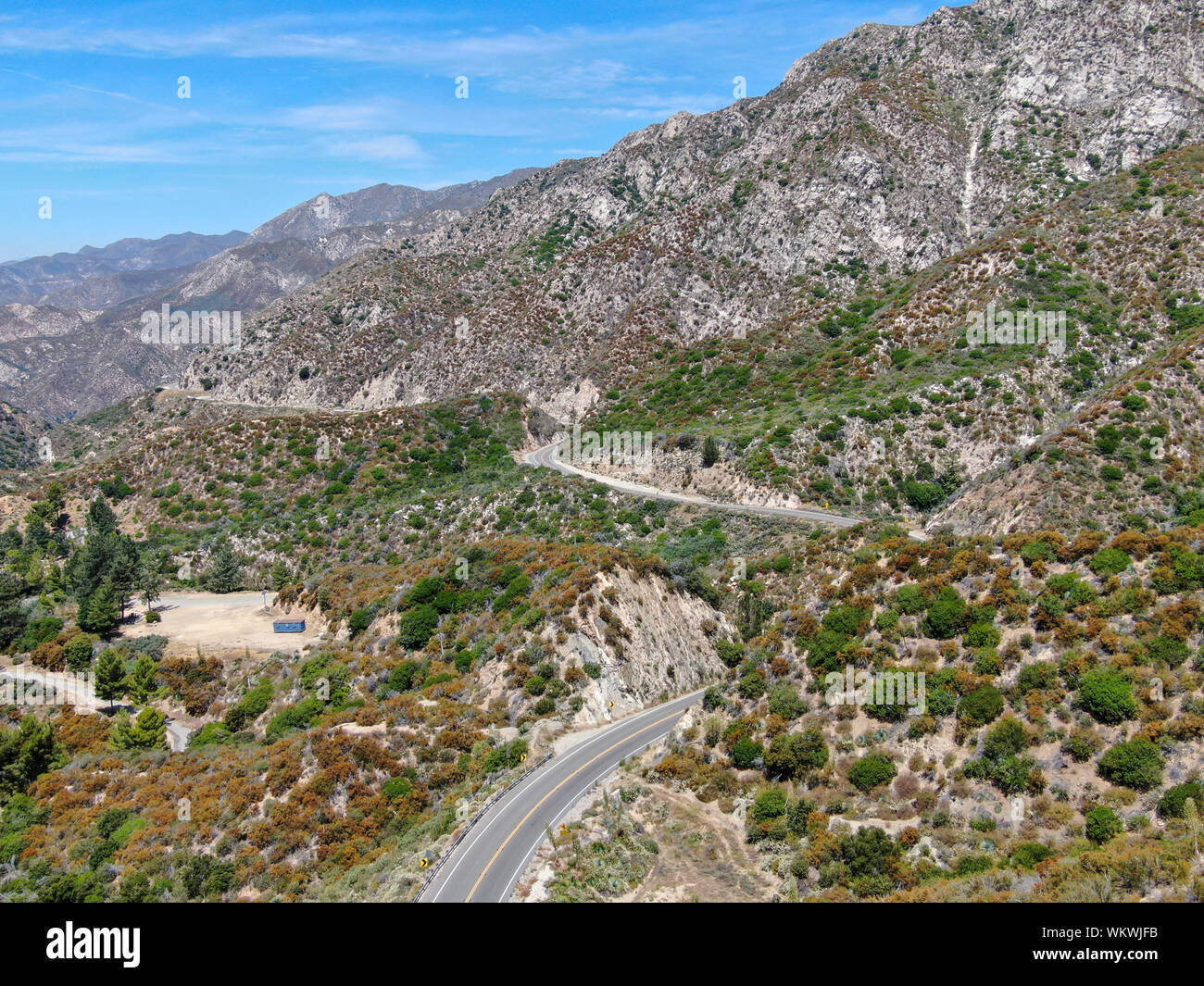 Asphalt road bends through Angeles National forests mountain ...