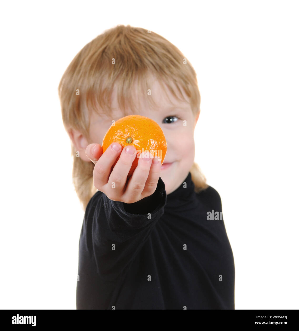 The cheerful child with orange isolated on white background Stock Photo ...