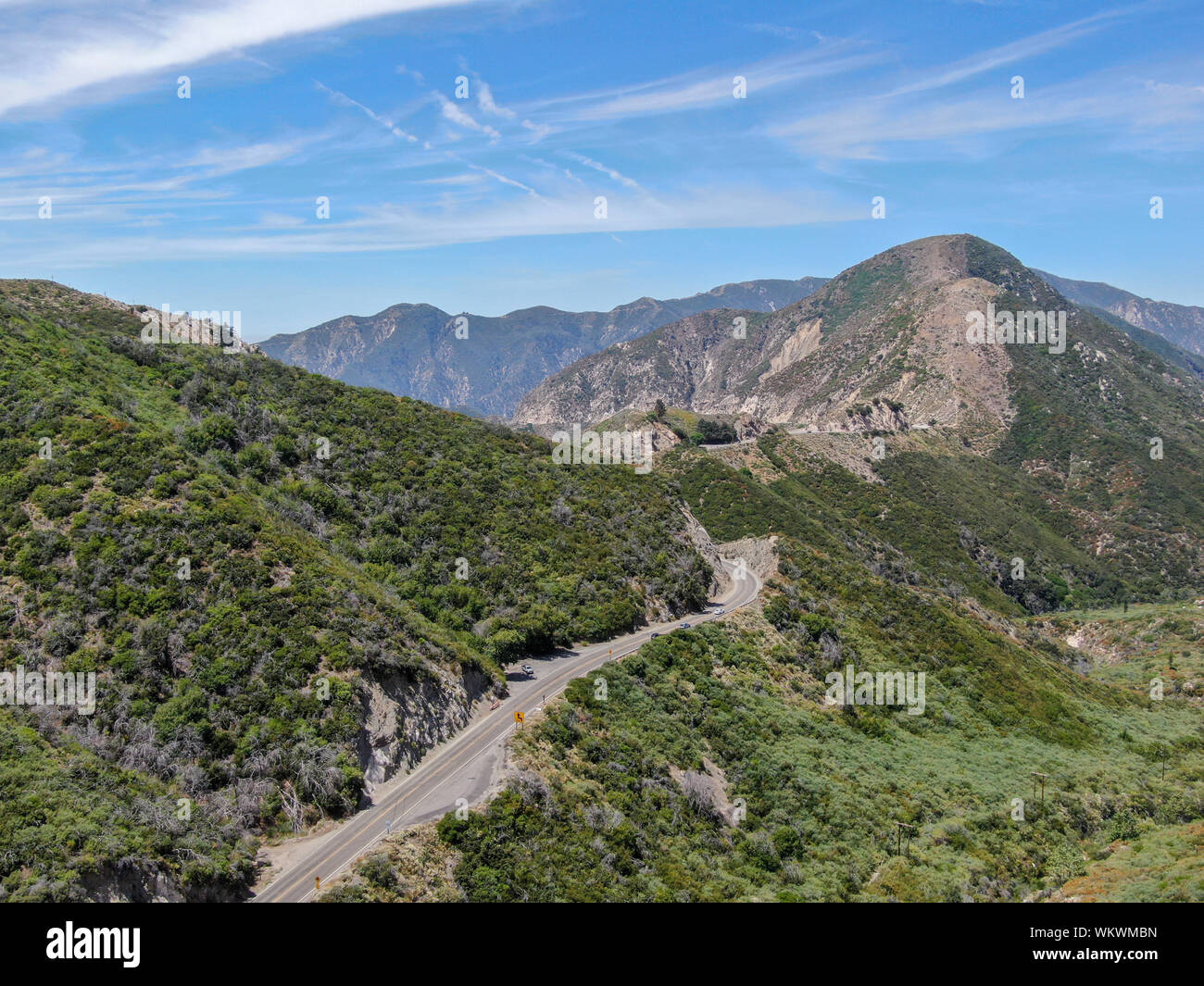 Asphalt road bends through Angeles National forests mountain ...