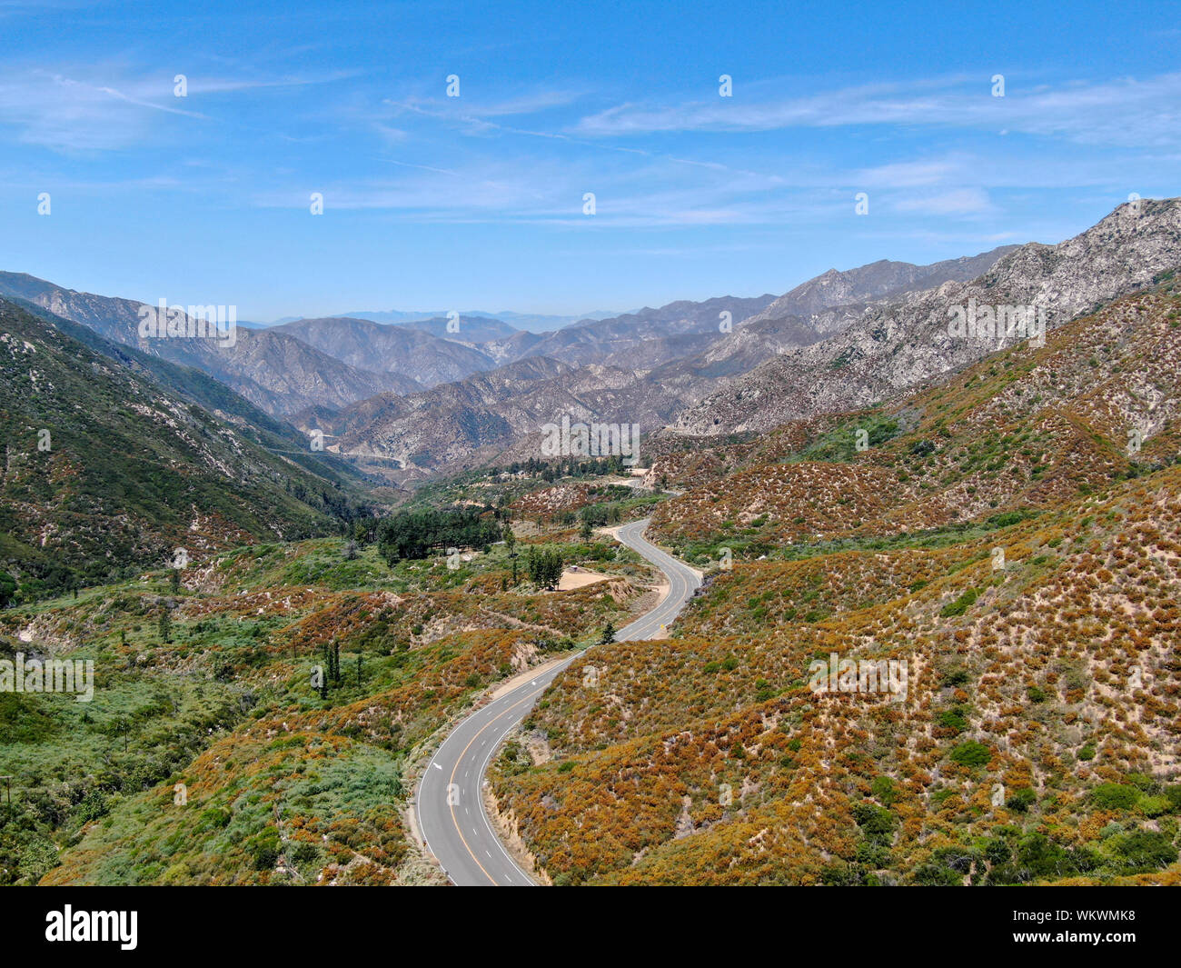Asphalt road bends through Angeles National forests mountain ...
