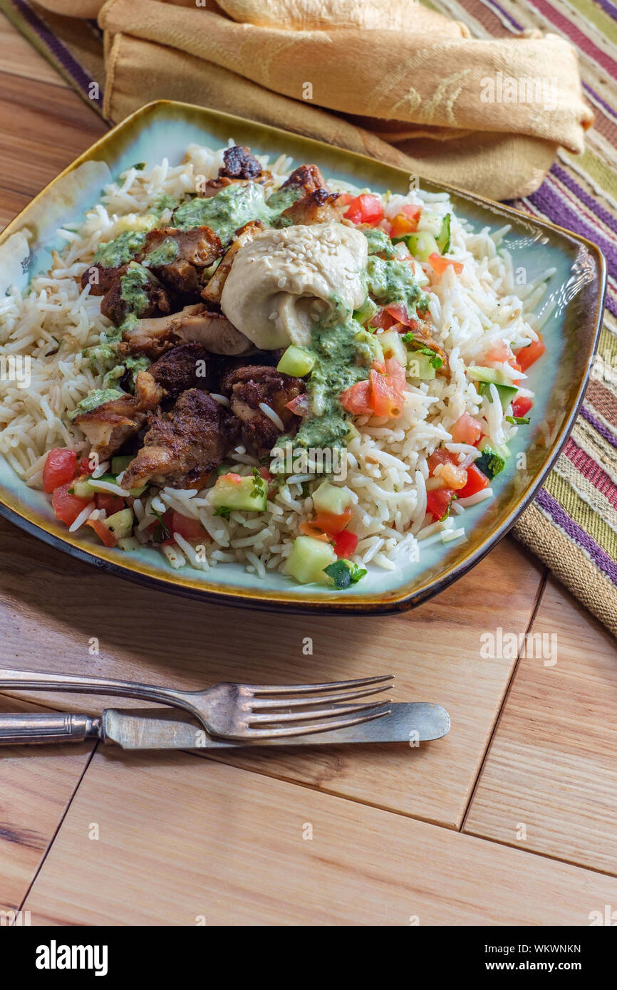 Authentic Middle Eastern chicken Shawarma rice platter with hummus and ...