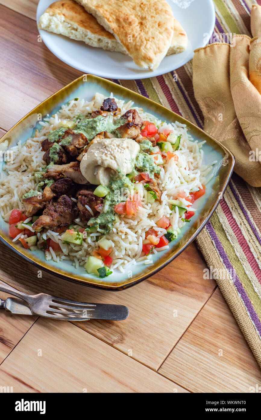 Authentic Middle Eastern chicken Shawarma rice platter with hummus and ...