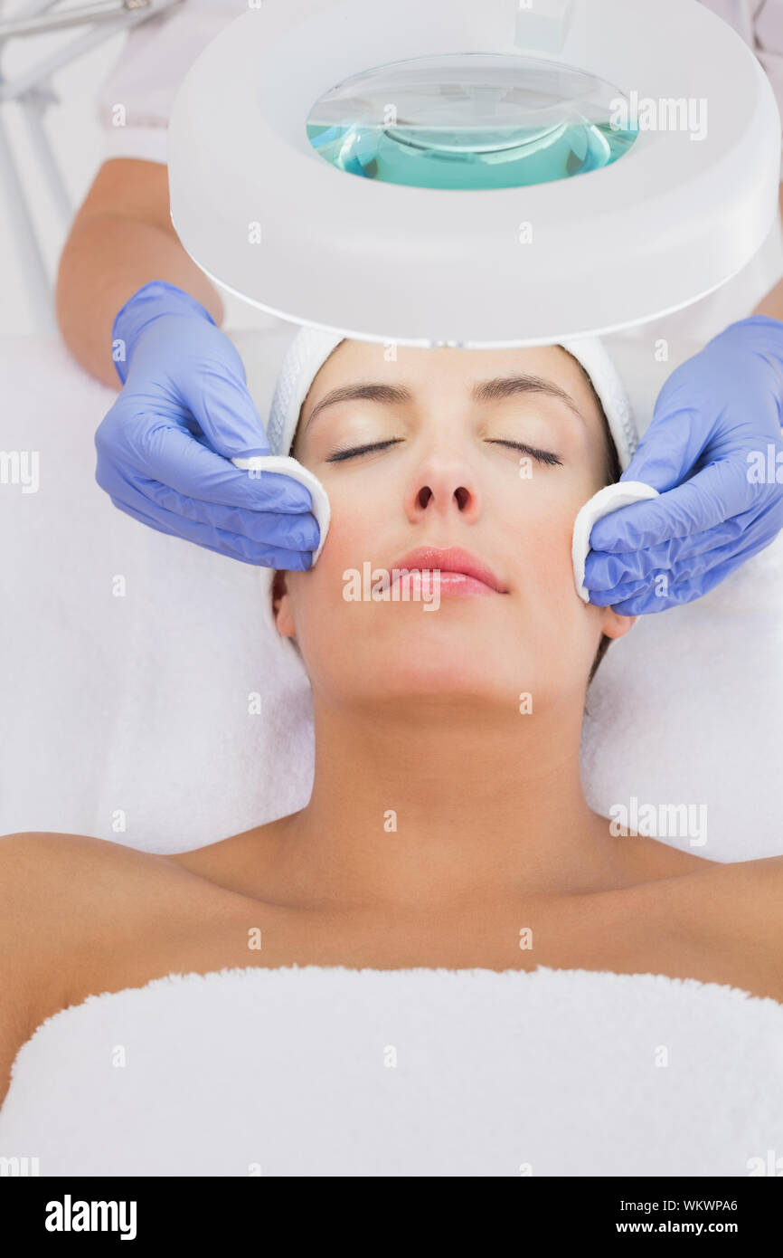 Hands cleaning woman's face with cotton swabs at spa center Stock Photo ...
