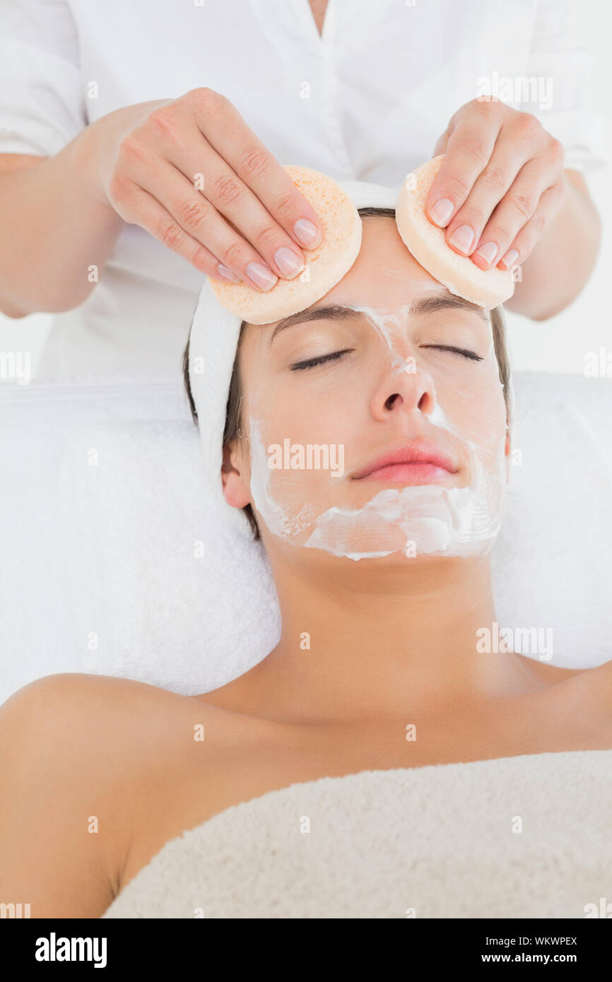 Hand cleaning woman's face with cotton swabs at spa center Stock Photo ...