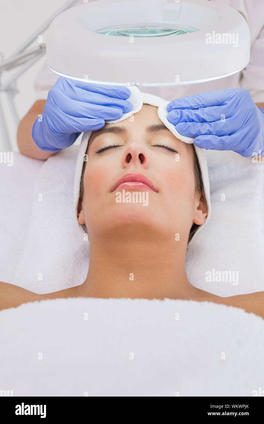 Hands cleaning woman's face with cotton swabs at spa center Stock Photo ...