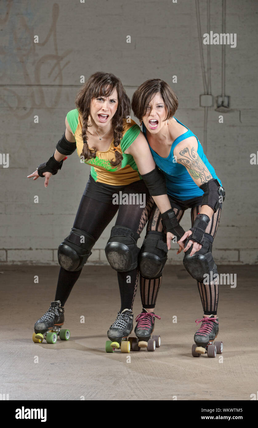 Aggressive women roller derby skaters threatening with a pose Stock ...
