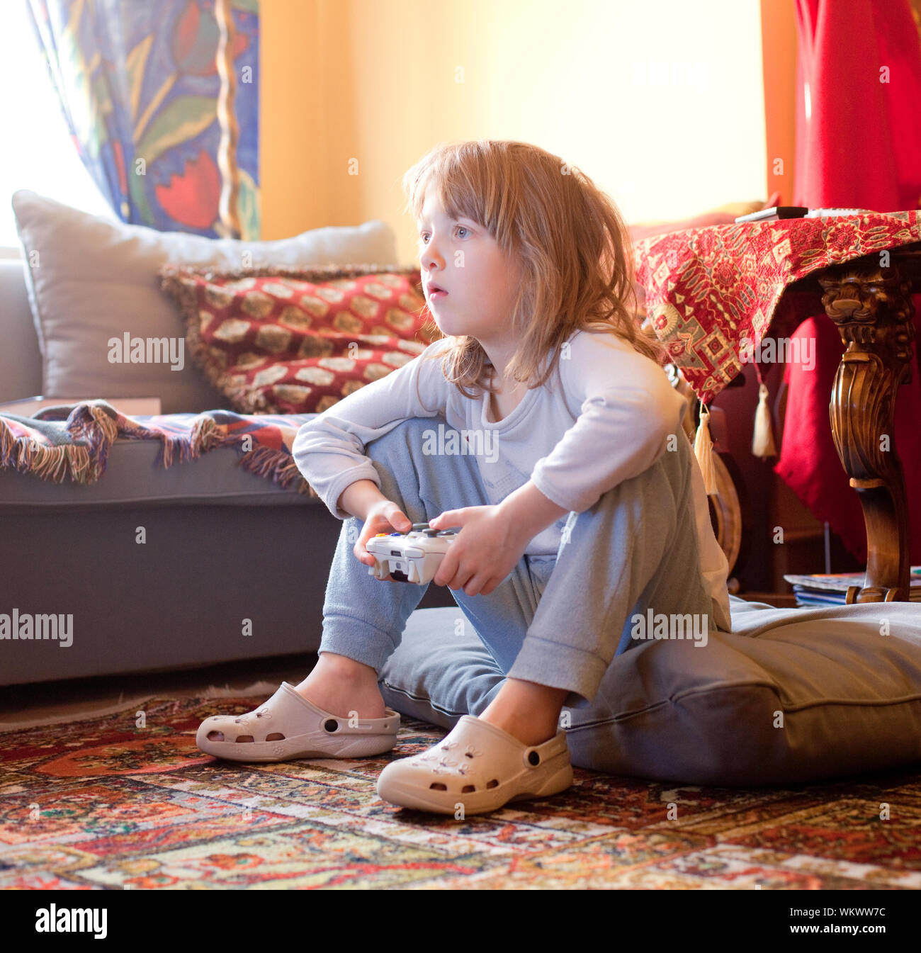 Boy Playing Console Game Sitting on the Floor Stock Photo - Alamy