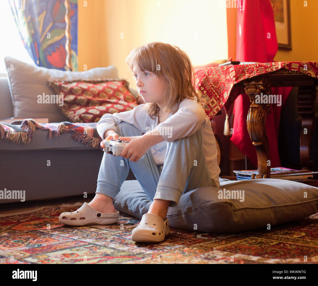 Boy Playing Console Game Sitting on the Floor Stock Photo - Alamy