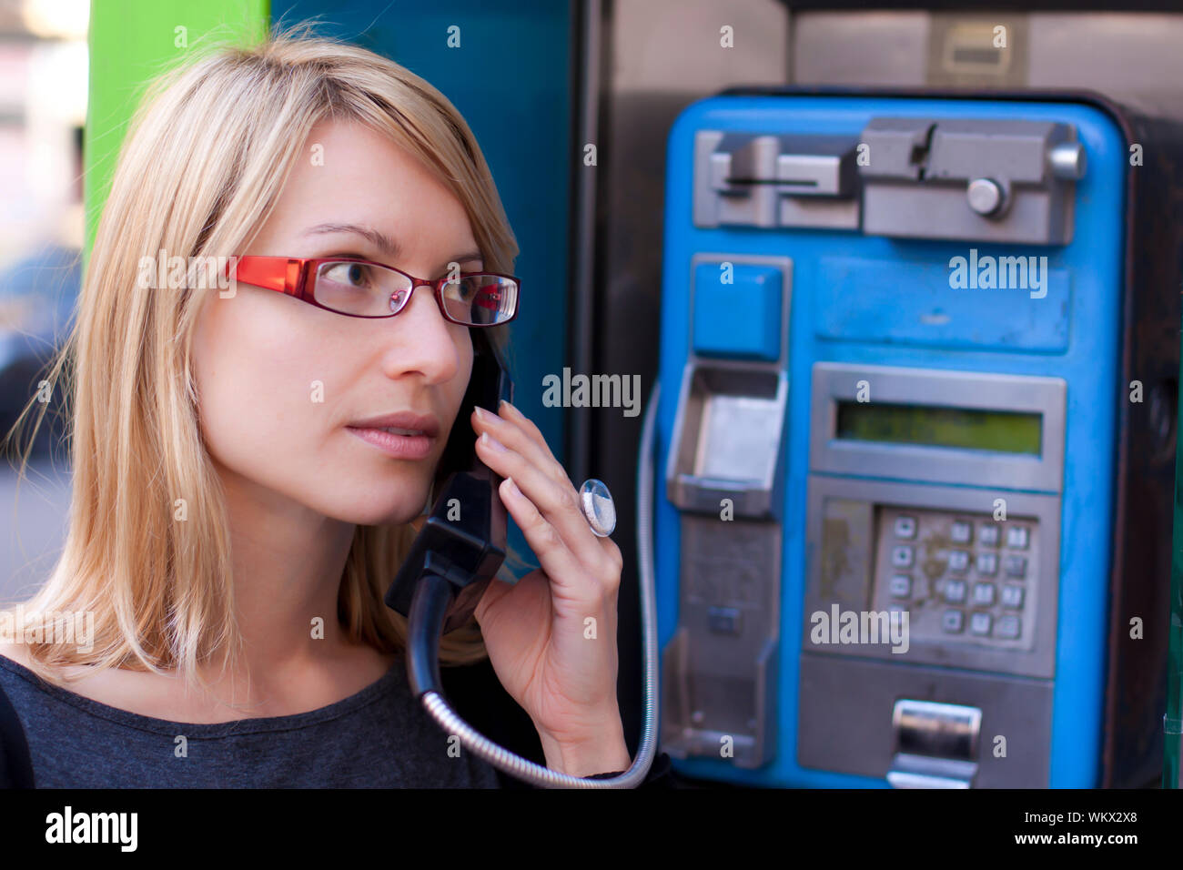 Woman talking on the phone in a retro phone boot Stock Photo - Alamy