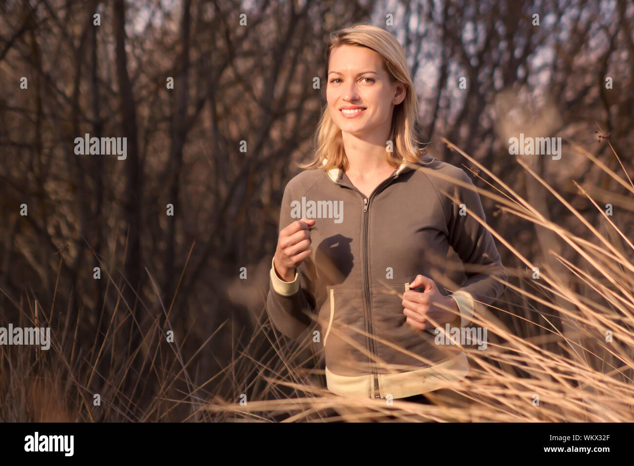 Young beautiful girl running in the autumn environment Stock Photo - Alamy