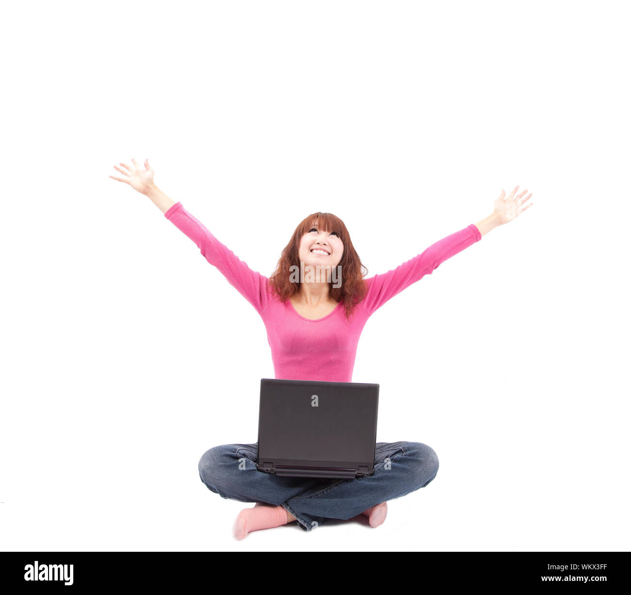 Happy girl sitting and using a laptop Stock Photo - Alamy