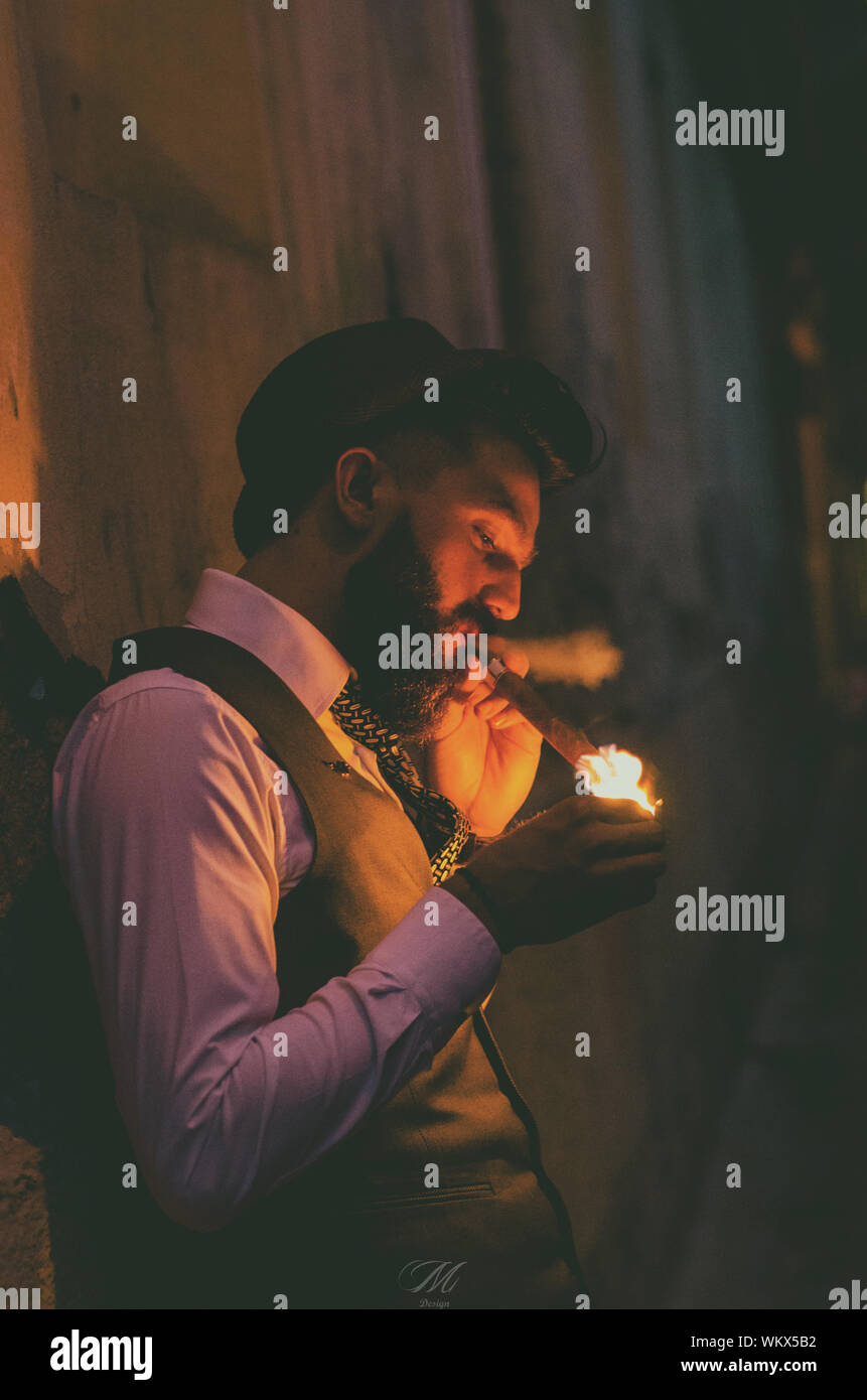 Young man smoking cigar outdoors hi-res stock photography and images ...