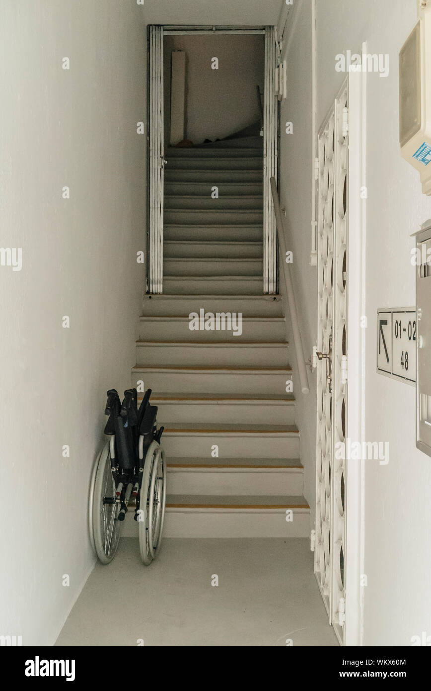 Wheelchair By Steps In Building Stock Photo - Alamy