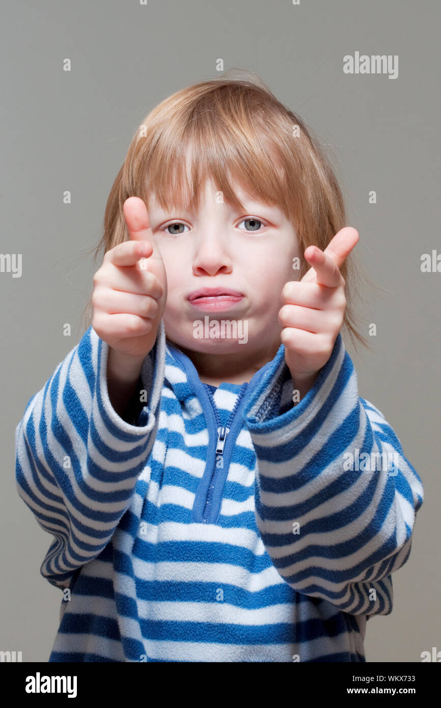 boy with long blond hair pointing imaginary gun shooting - isolated on ...