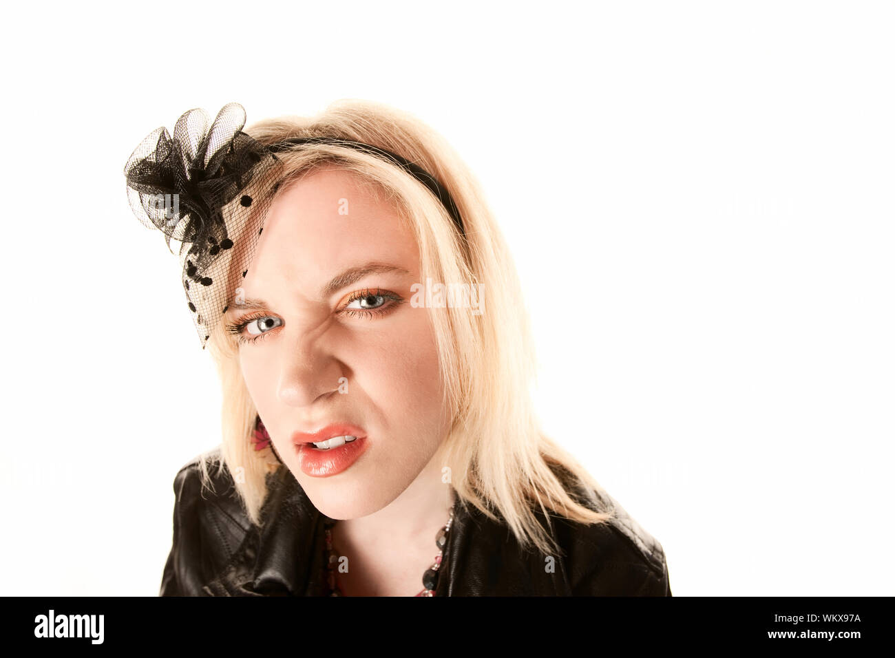 Pretty blonde woman with angry expression on her face Stock Photo - Alamy