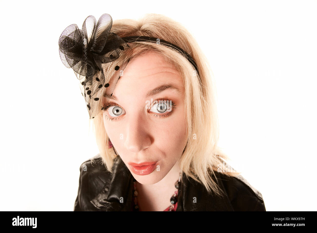 Pretty blonde woman with confused expression on her face Stock Photo ...