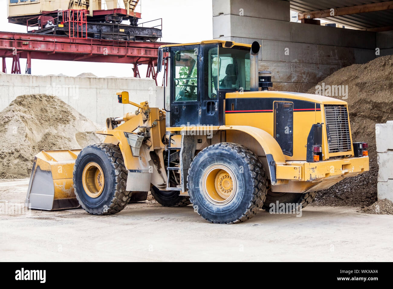 Parked pay loader near pile of dirt at a construction site Stock Photo ...