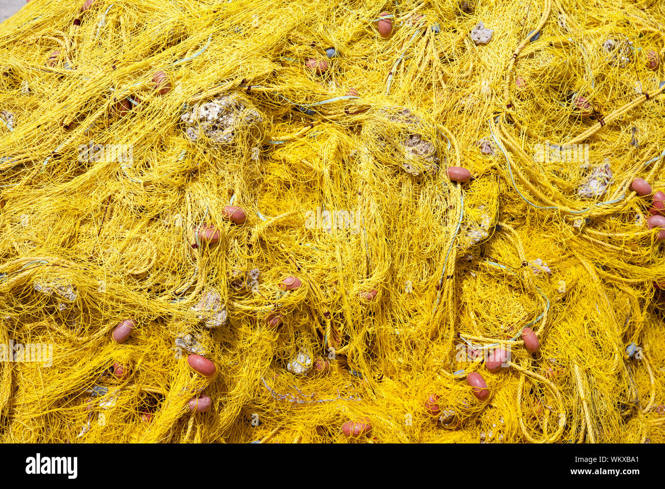 Yellow fishing net with floats background Stock Photo - Alamy