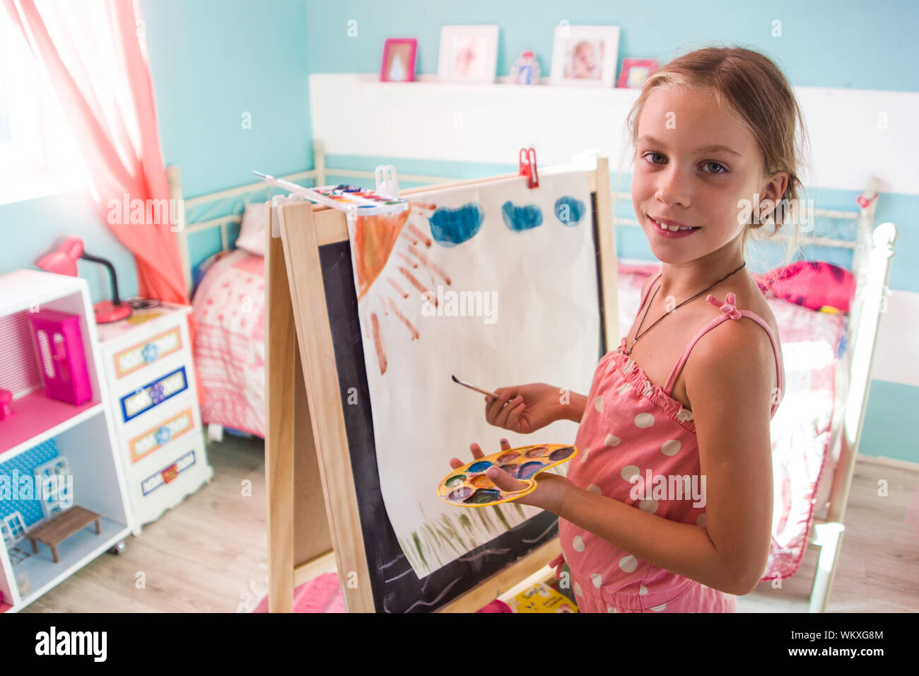 7-8 years old child drawing on easel in child room at home Stock Photo ...