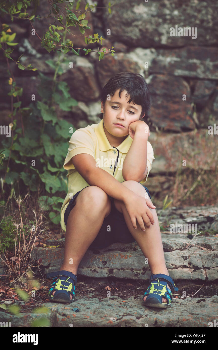 Portrait of sad little boy outdoor Stock Photo - Alamy