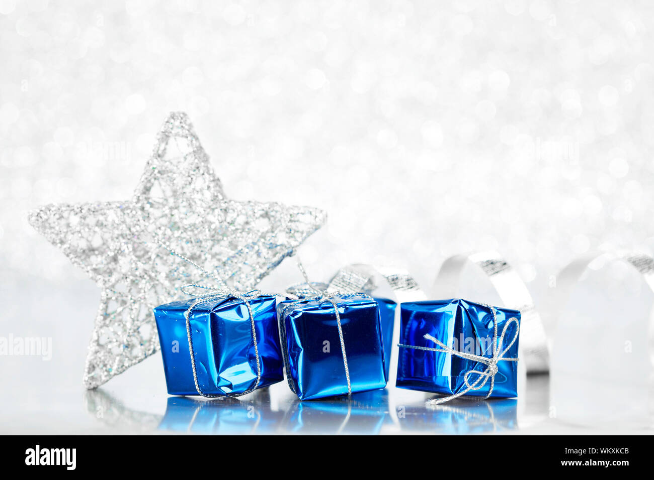 Christmas blue gifts and decoration on shiny silver background Stock ...