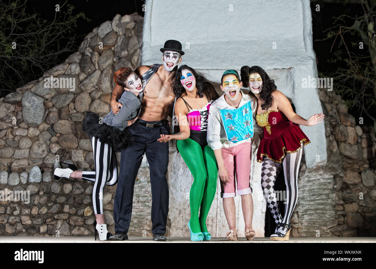 Group of surreal clowns on stage laughing Stock Photo - Alamy