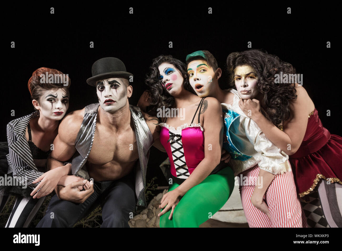 Five serious cirque clowns on theater stage Stock Photo - Alamy