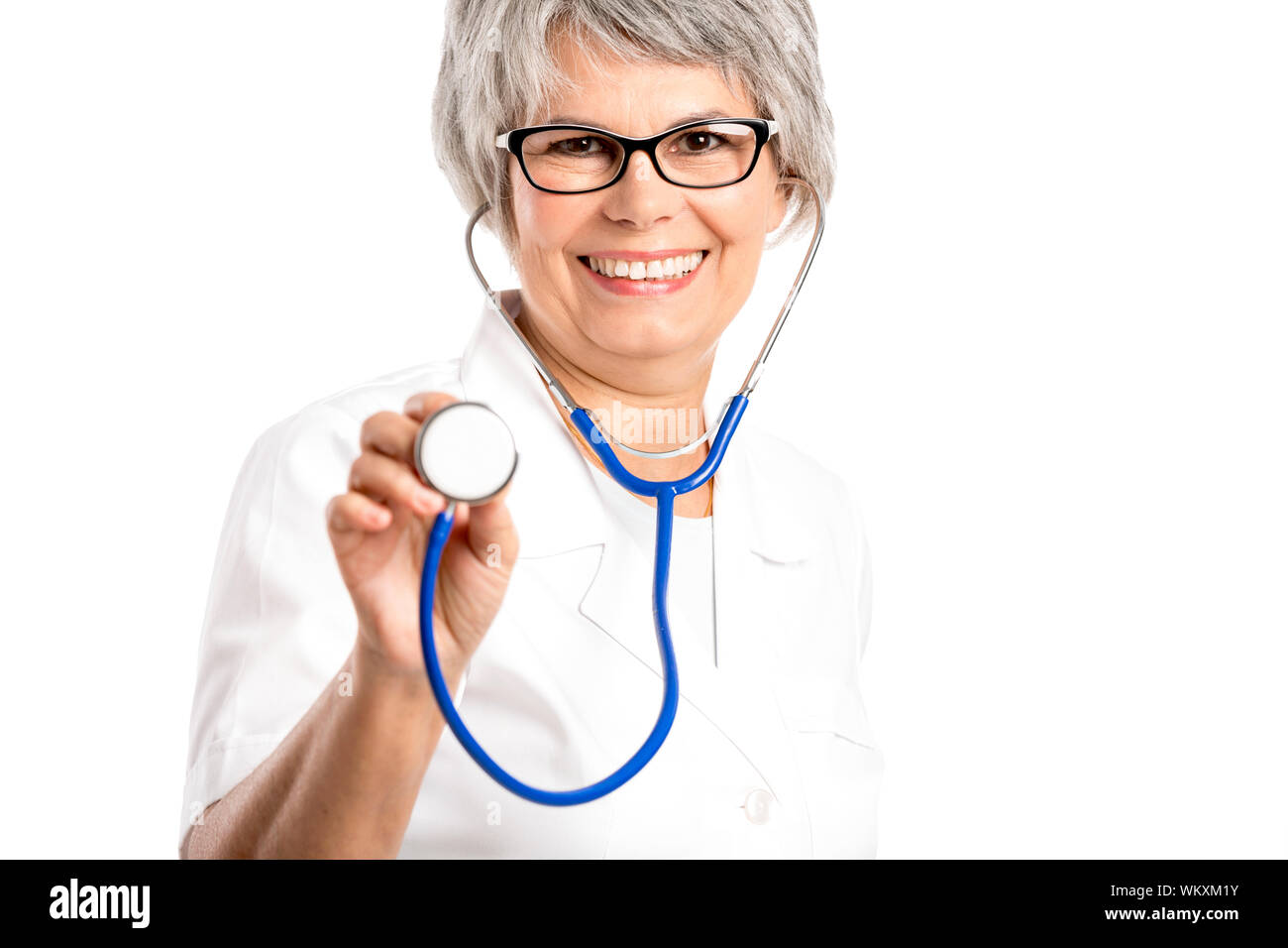 Happy old female doctor holding a stethoscope, isolated on white Stock ...