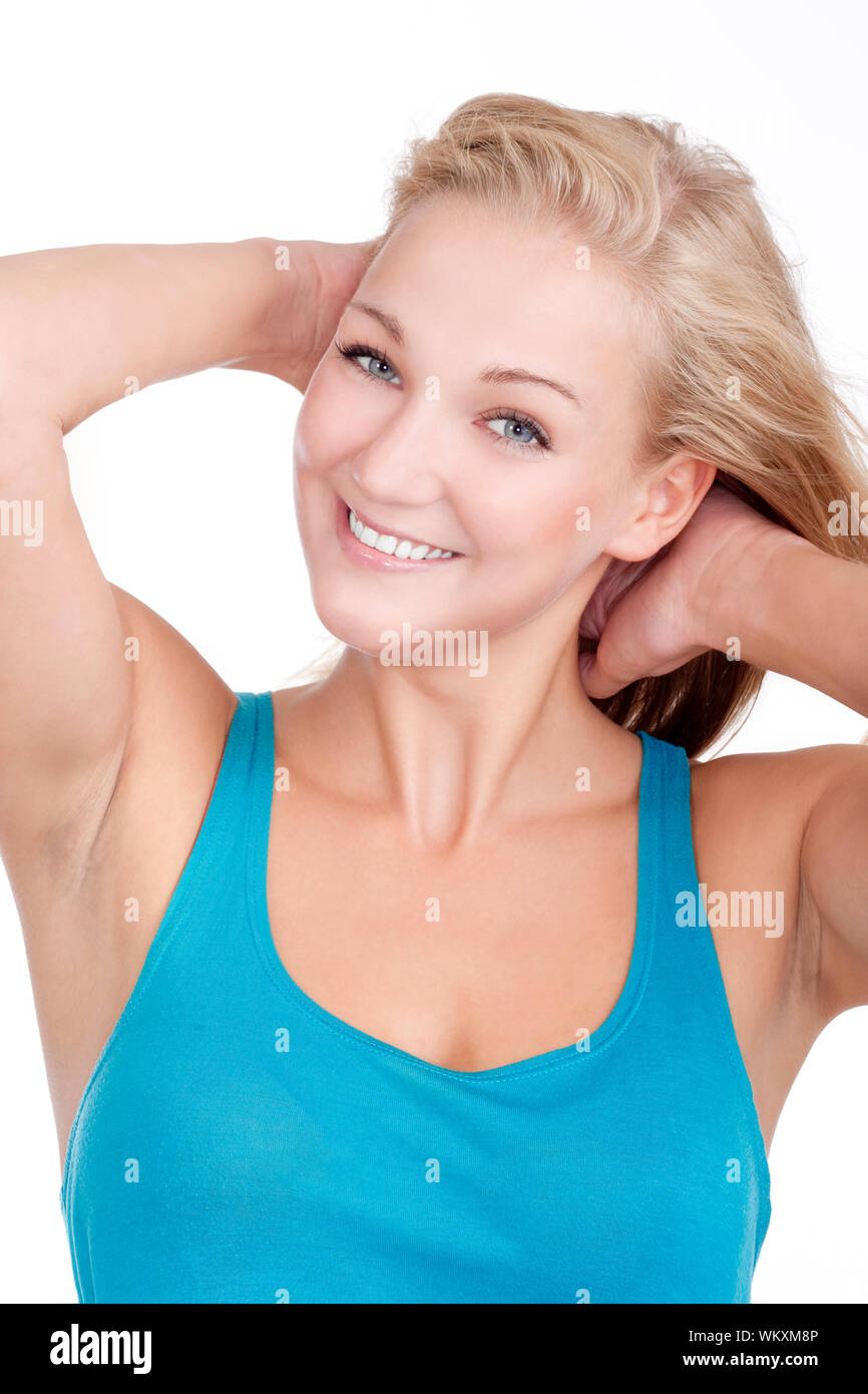 portrait of a young blond woman in blue top smiling - isolated on white ...