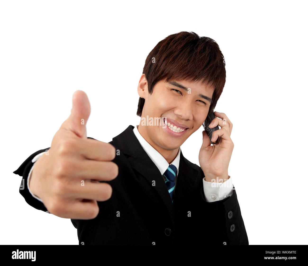 Young business Man With mobile phone and Thumbs Up Stock Photo - Alamy