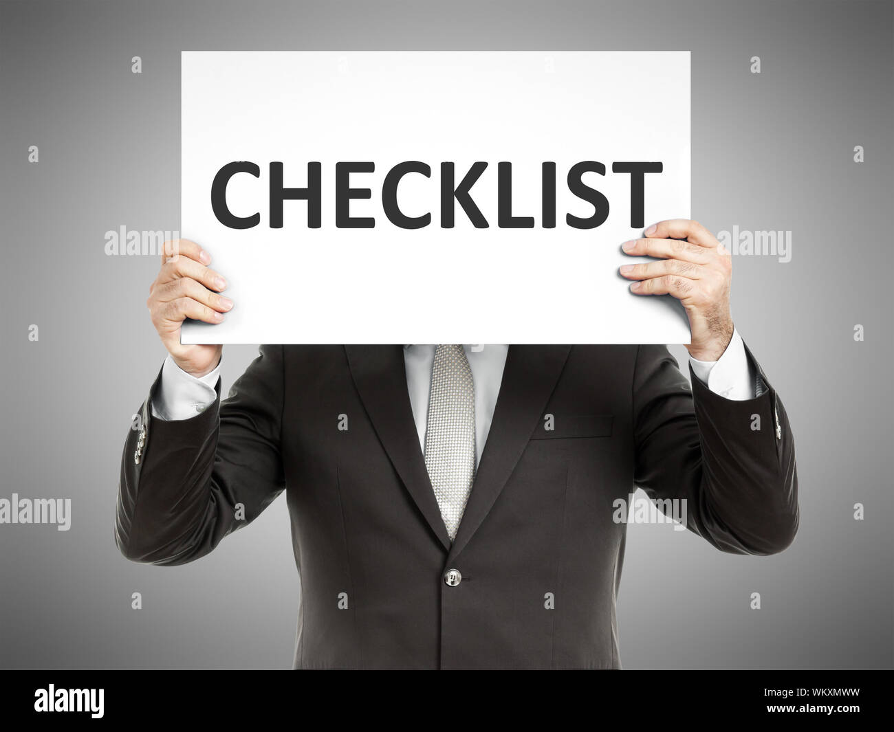 A business man holding a paper in front of his face with the text ...