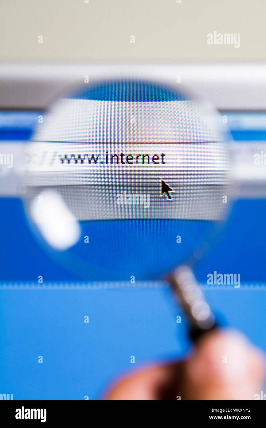 Magnifying glass on top of search icon of computer screen Stock Photo ...