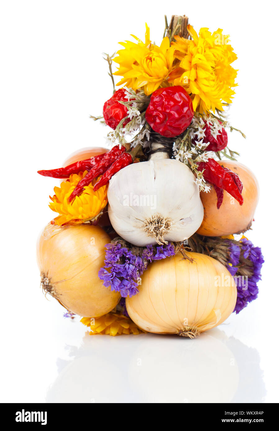 Braided bunch with onions, garlic and flowers, over white background ...