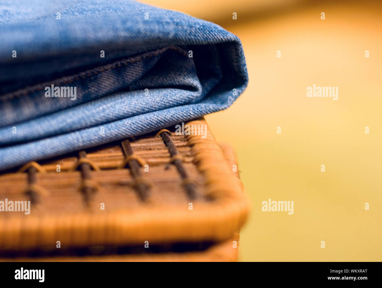 Blue jeans atop of a basket Stock Photo - Alamy