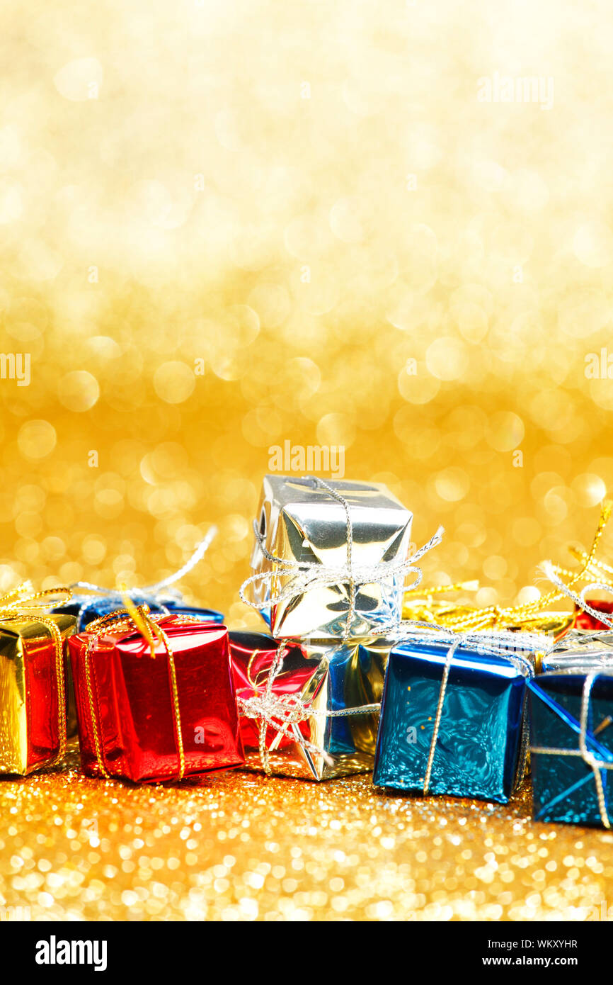 Small decorative colorful presents on glitter background Stock Photo ...