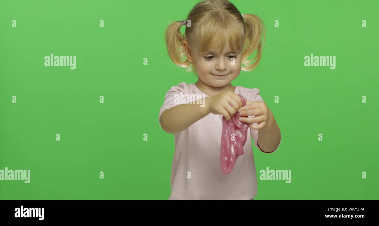 Child having fun making ping slime. Kid playing with hand made toy ...